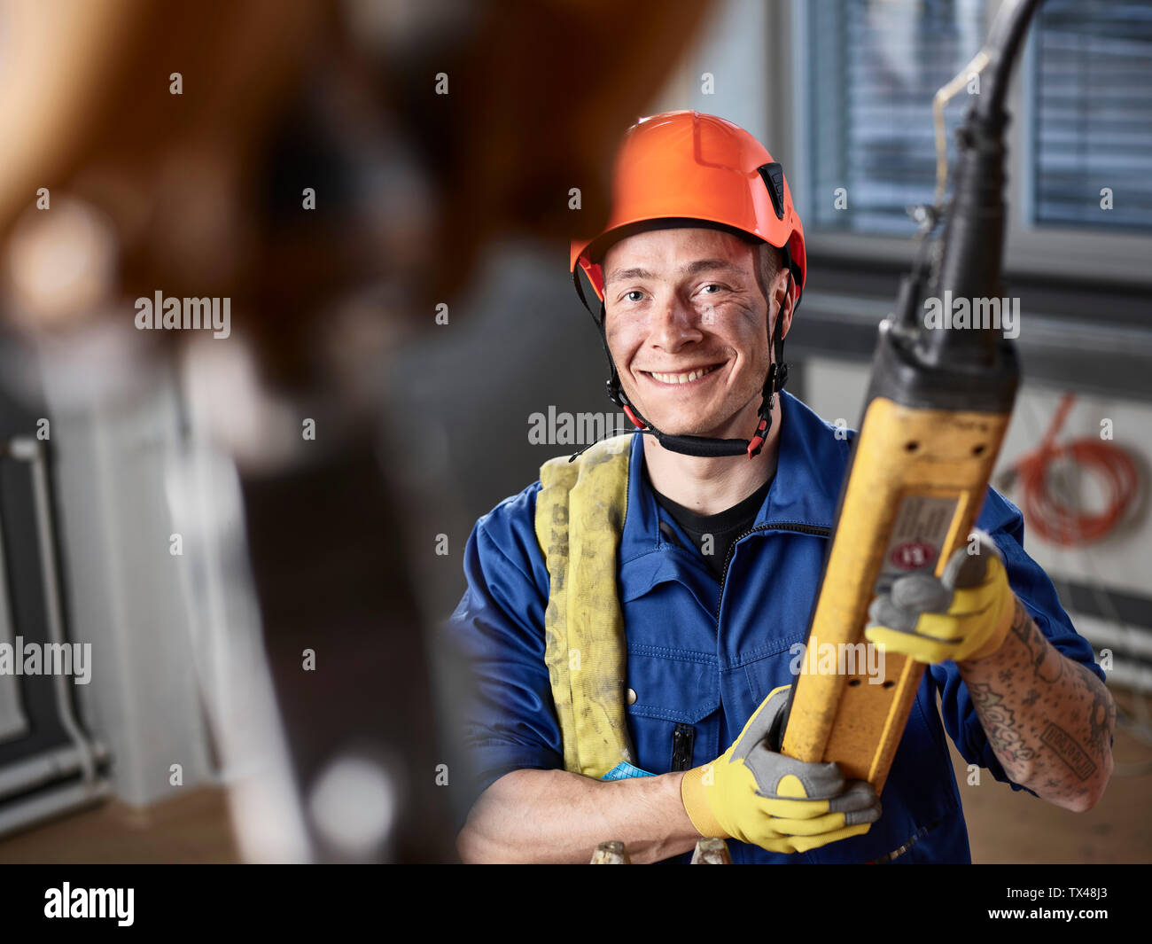 Industrial worker using hand control of indoor crane Stock Photo - Alamy