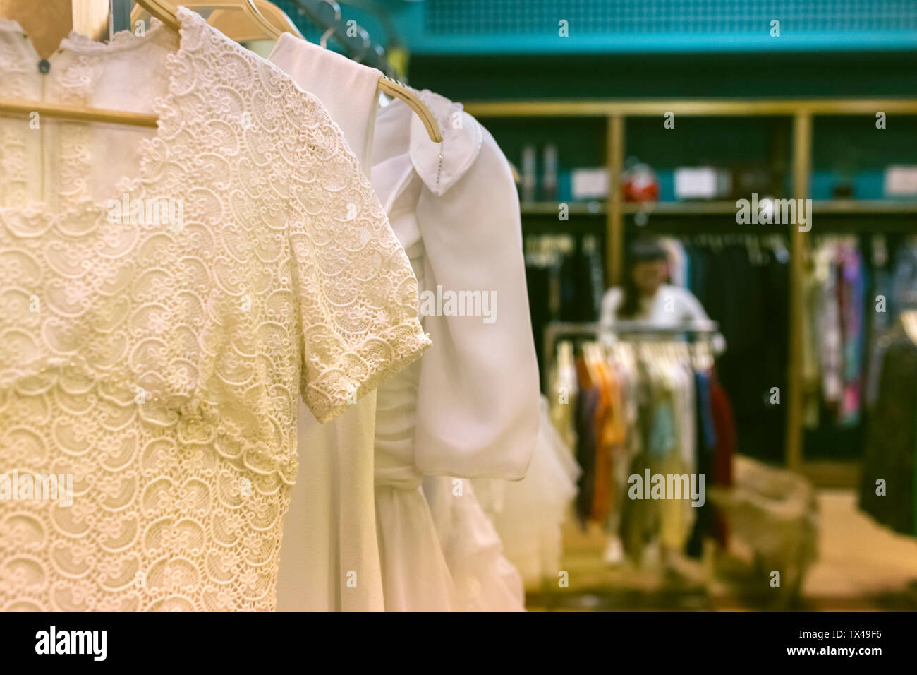 Vintage boutique with woman in background Stock Photo - Alamy