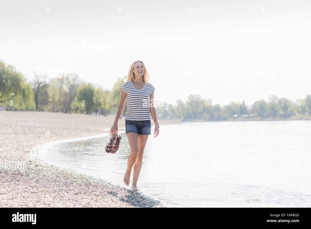 Mature woman wading in water hi-res stock photography and images - Alamy