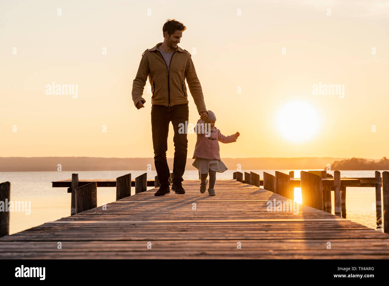 Happy Father Holding Daughter Beach Sunset High Resolution Stock ...