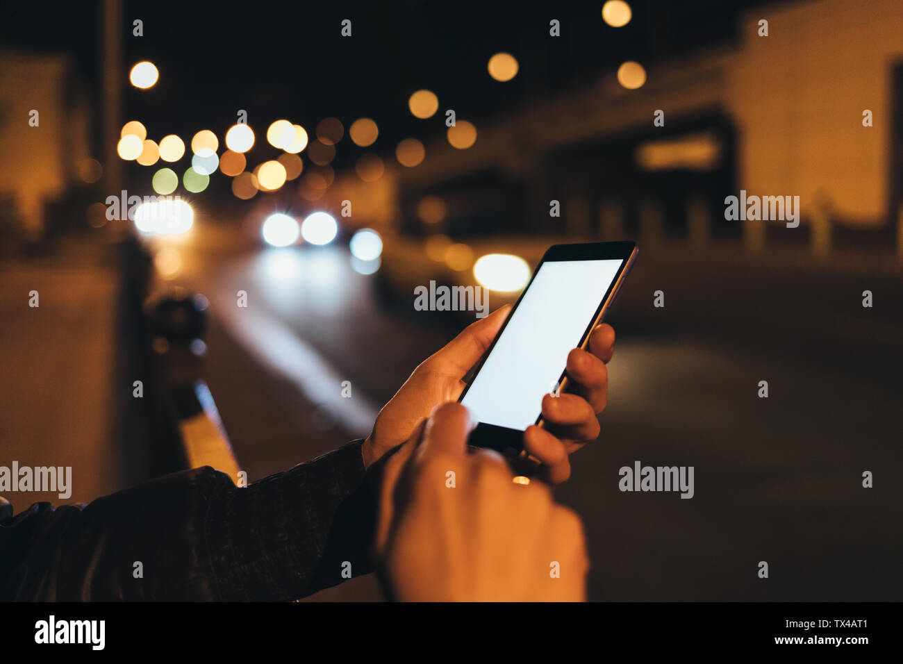 Close-up young woman's hands holding mobile phone with white screen ...