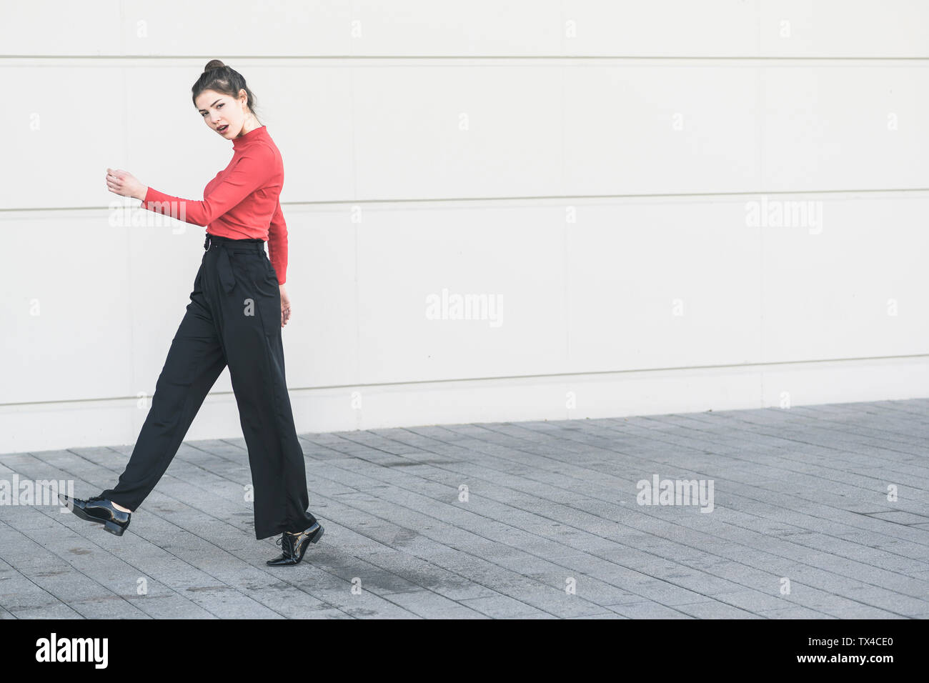 Woman walking along a wall hi-res stock photography and images - Alamy