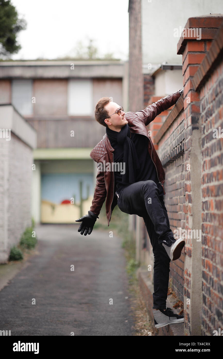 Climbing over wall hi-res stock photography and images - Alamy