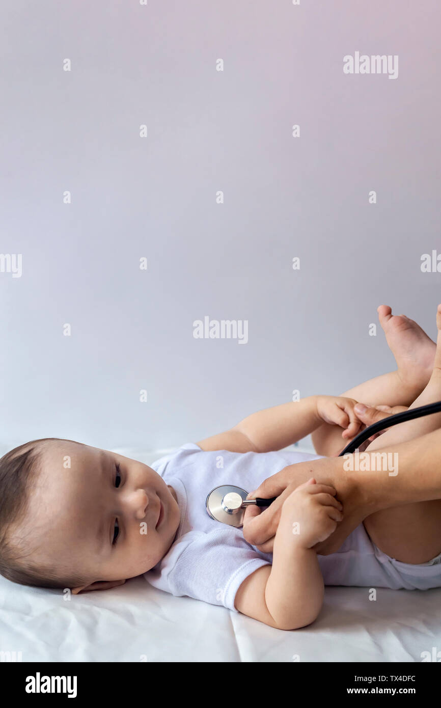 The Physical Checkup. Baby's Checkup. The pediatrician examining little ...