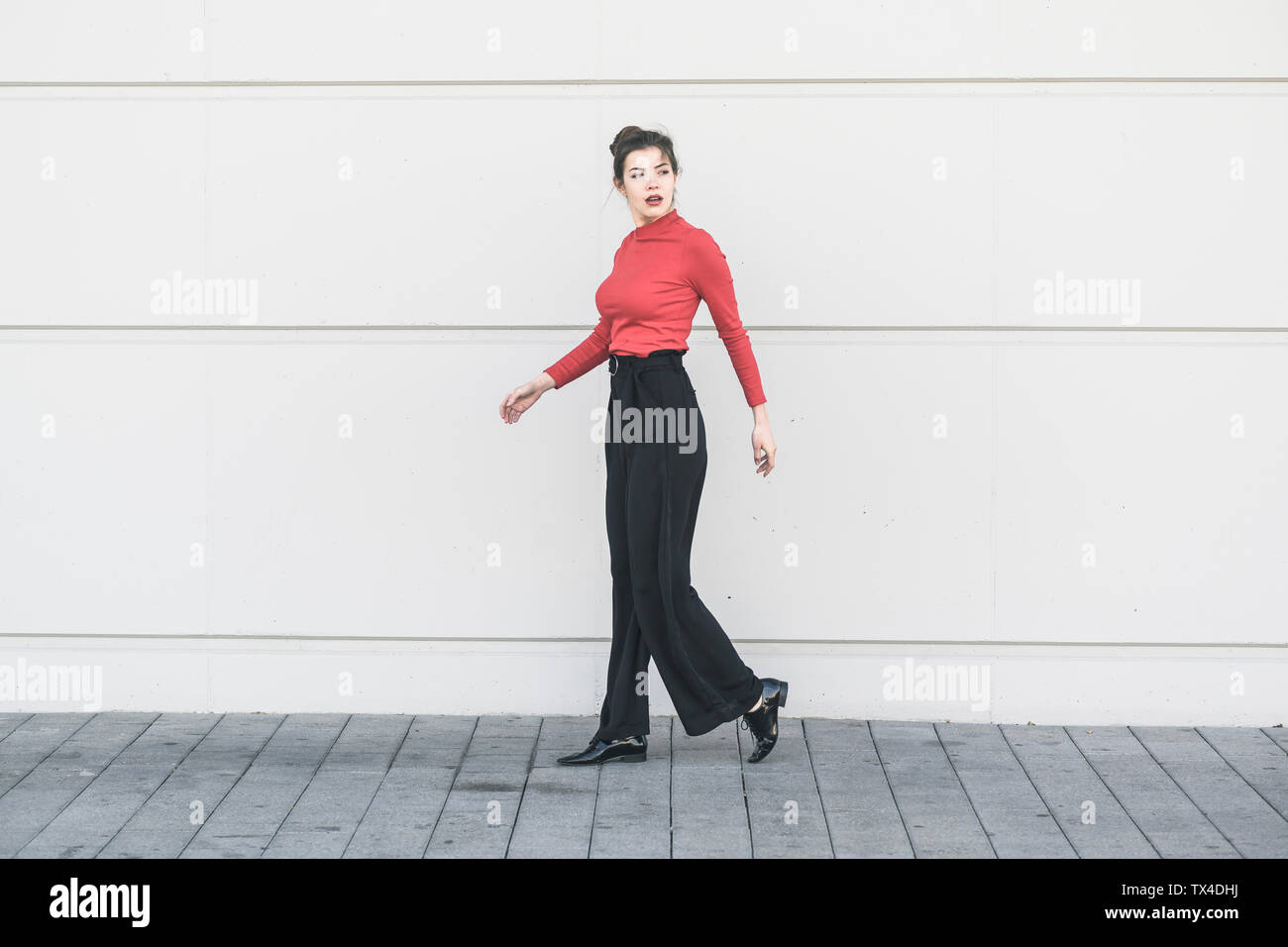 Woman walking along a wall hi-res stock photography and images - Alamy