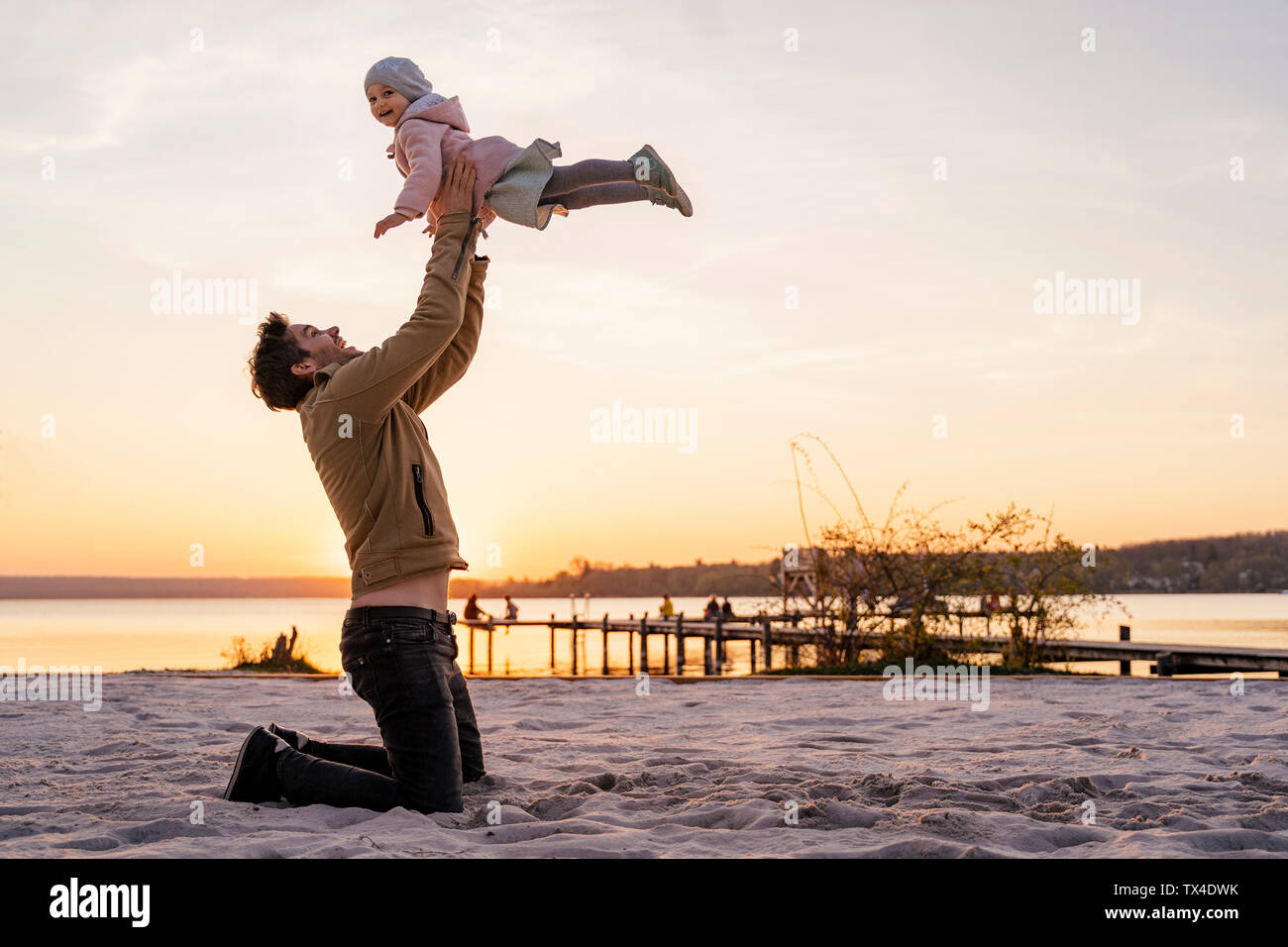 Happy Father Holding Daughter Beach Sunset High Resolution Stock ...