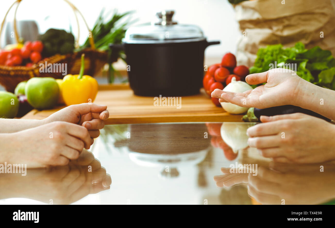 Closeup of human hands discussing something while cooking in kitchen ...