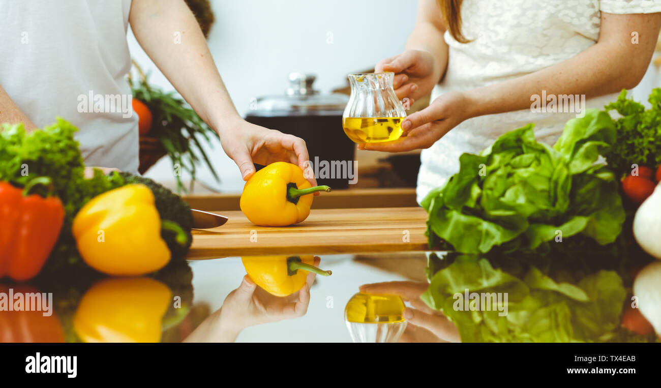 Closeup of human hands cooking in kitchen. Mother and daughter or two ...
