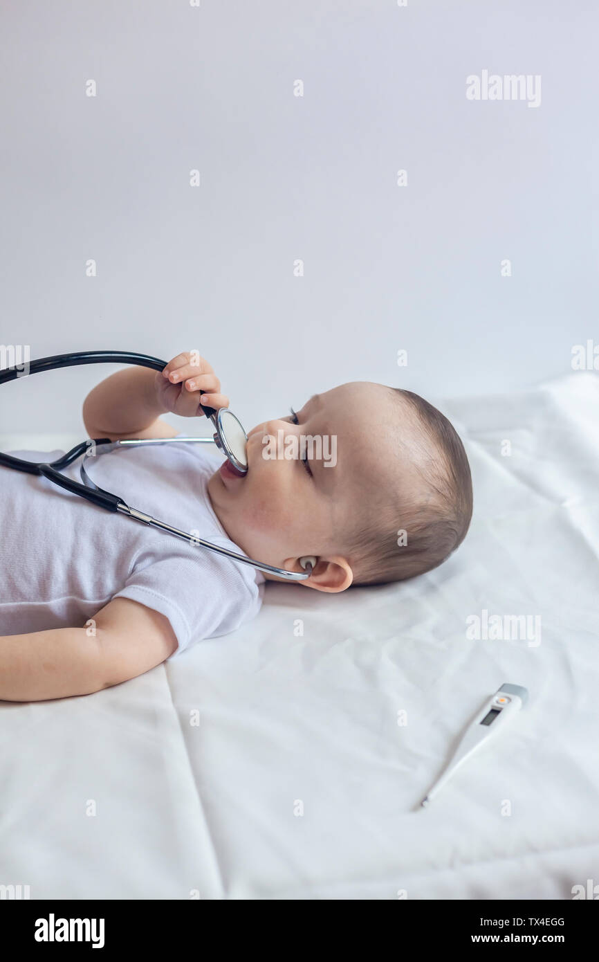 Little cute baby doctor. 6-month old baby boy playing with a ...
