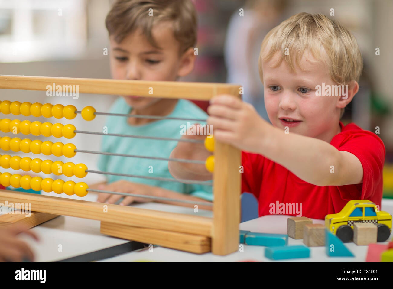 Boys in kindergarten using abacus Stock Photo - Alamy