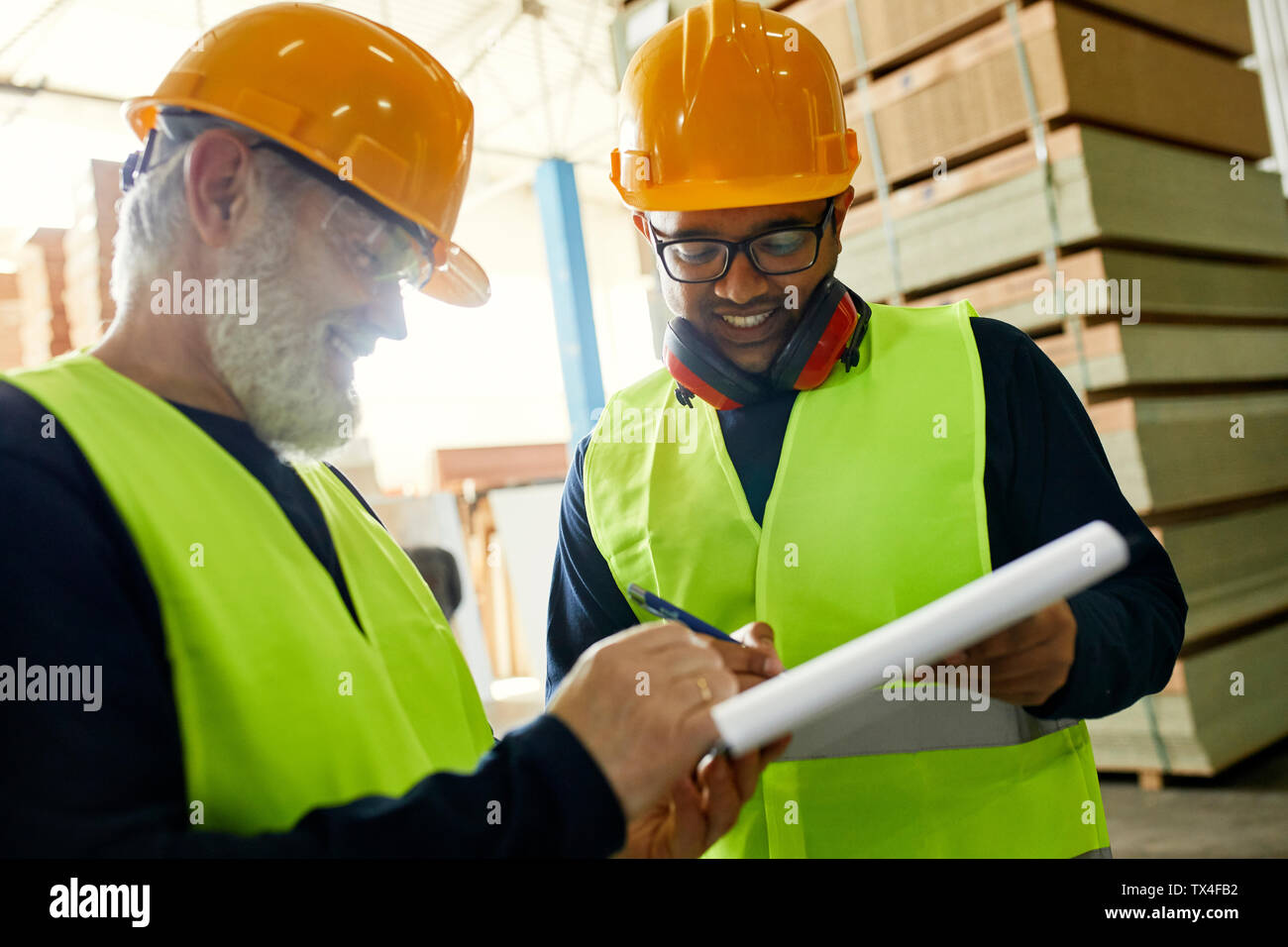 Two business people signing document hi-res stock photography and ...