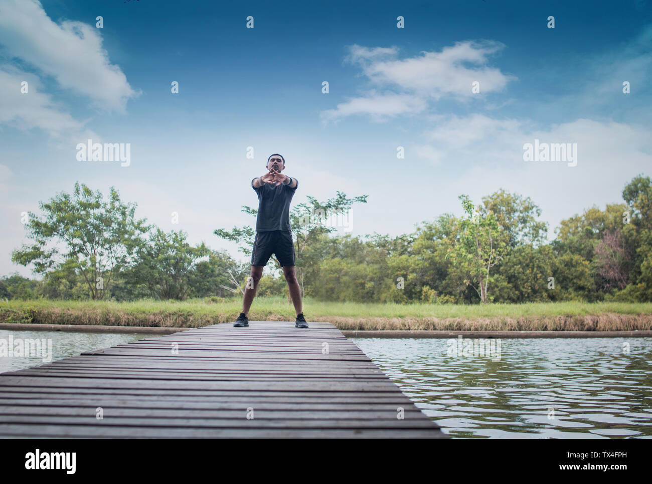 sport man exercise and worm up on bridge with river background, runner ...