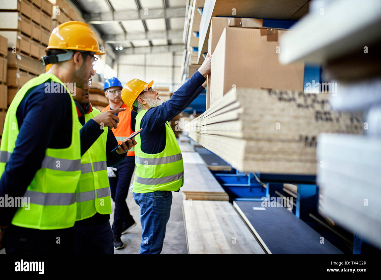 Men working in factory warehouse Stock Photo - Alamy