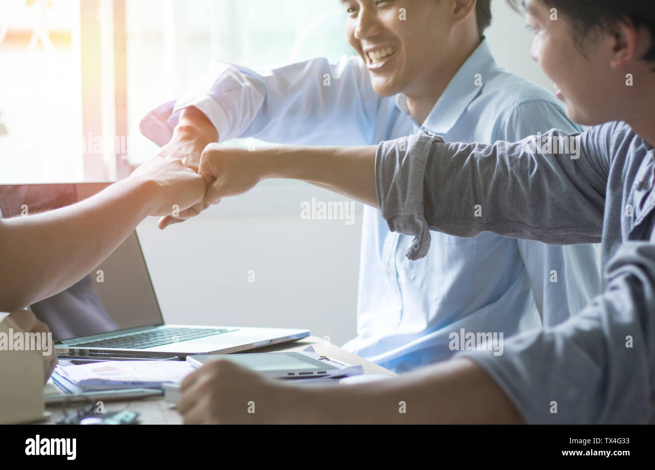 group of man punch in office, teamwork concept Stock Photo - Alamy