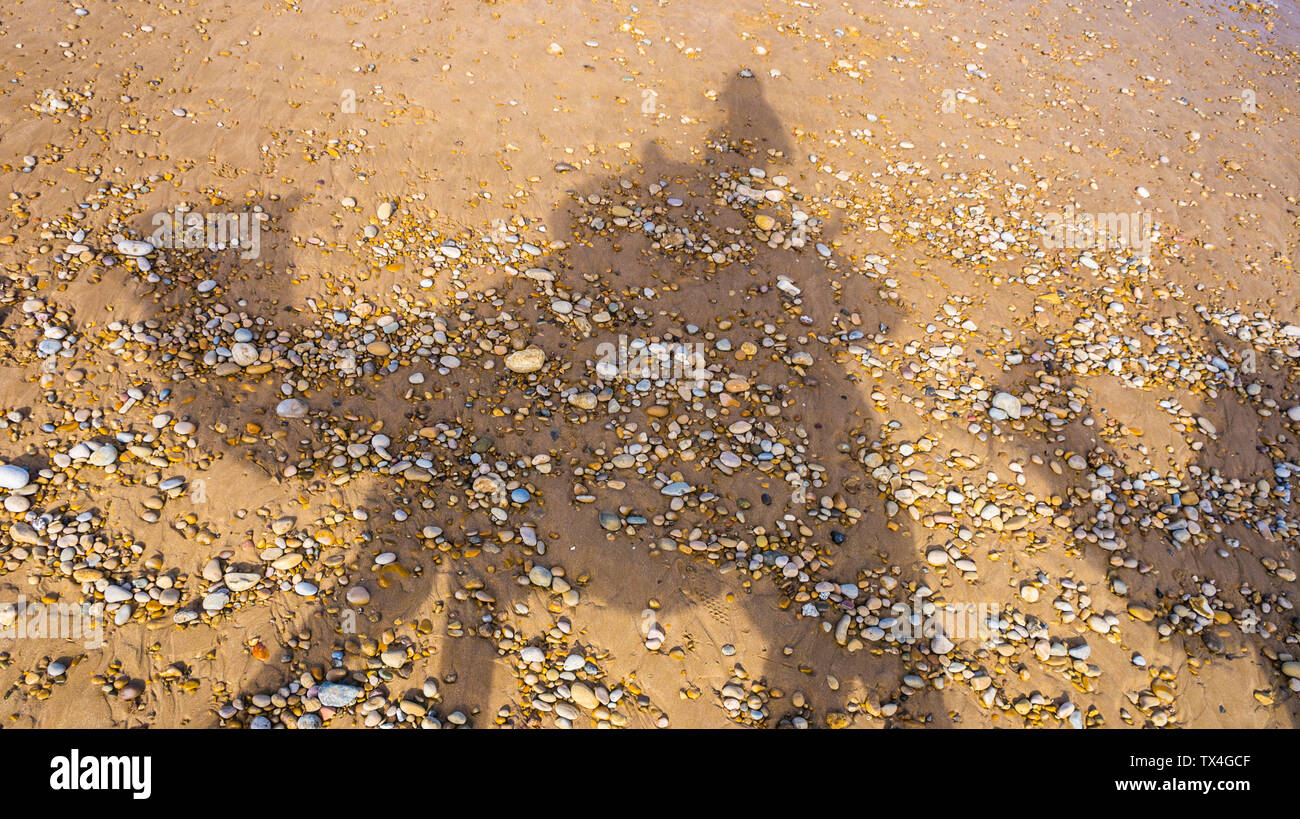 Morocco, Essaouira, Plage Tagharte, shadow of camel on the beach Stock ...