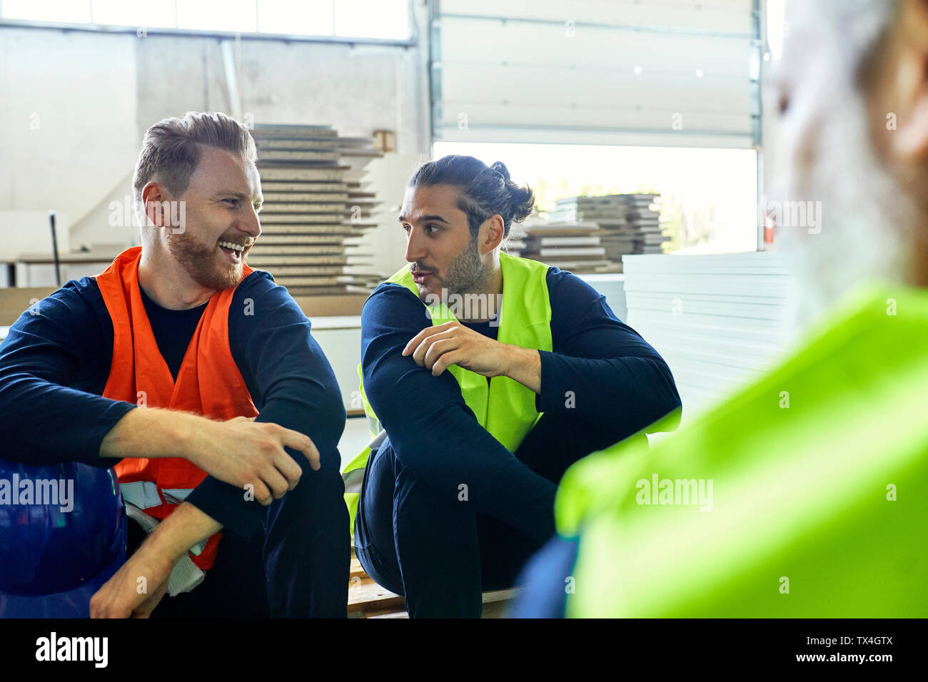Two happy workers in factory having lunch break Stock Photo - Alamy