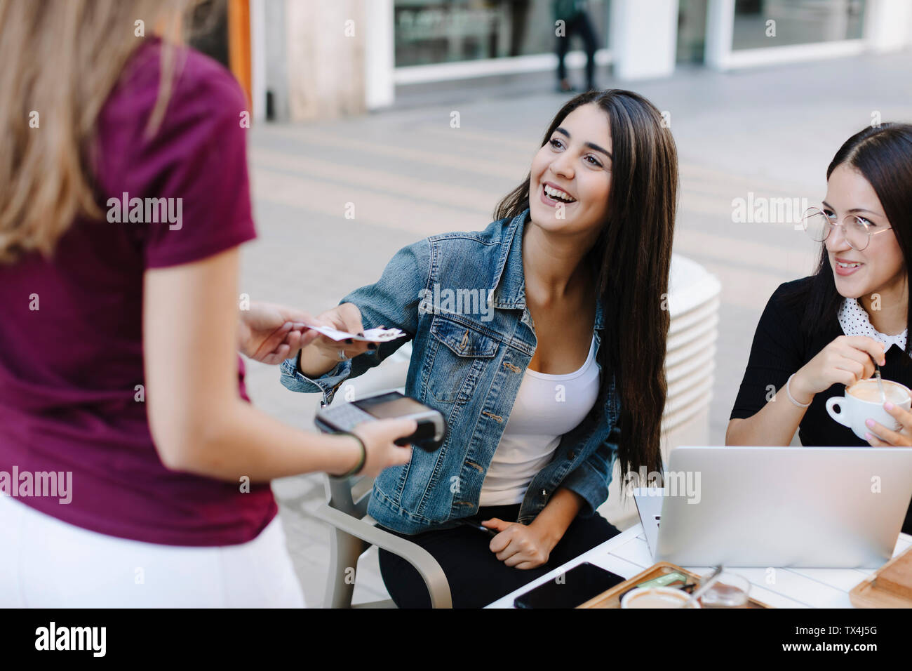 Woman group people paying bill cafe hi-res stock photography and images ...