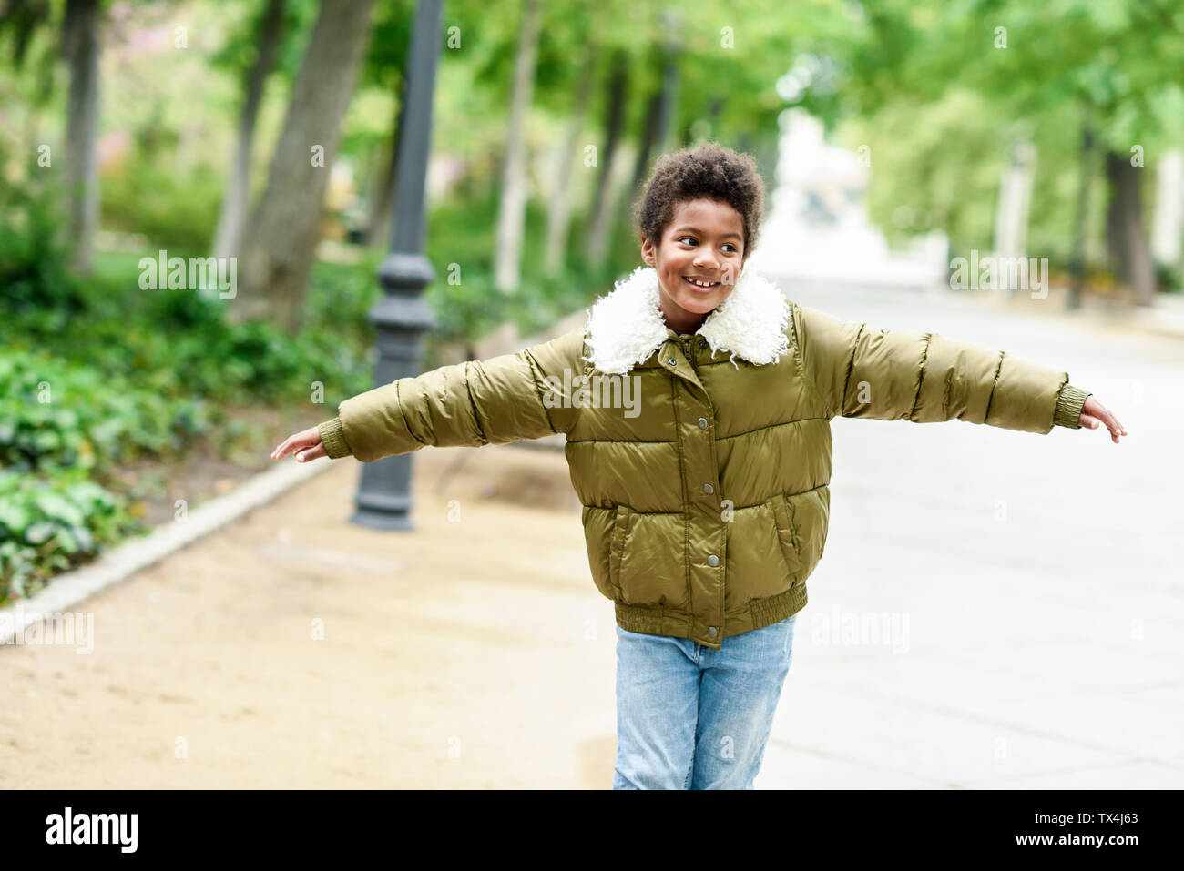 Happy boy balancing in a park Stock Photo - Alamy