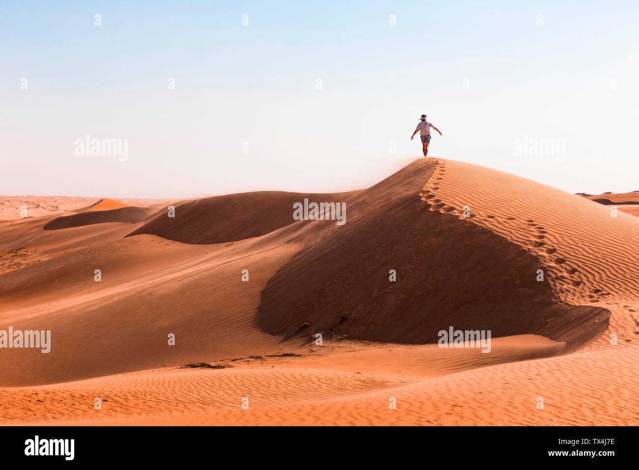 Man walking on a sand dune hi-res stock photography and images - Alamy