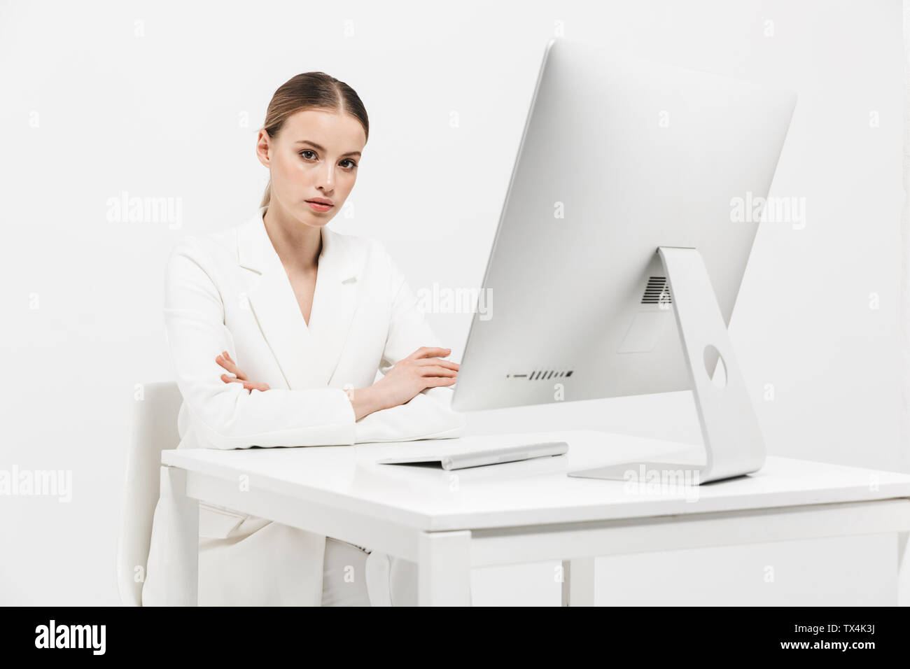 Image of a beautiful amazing woman sitting isolated over white wall ...