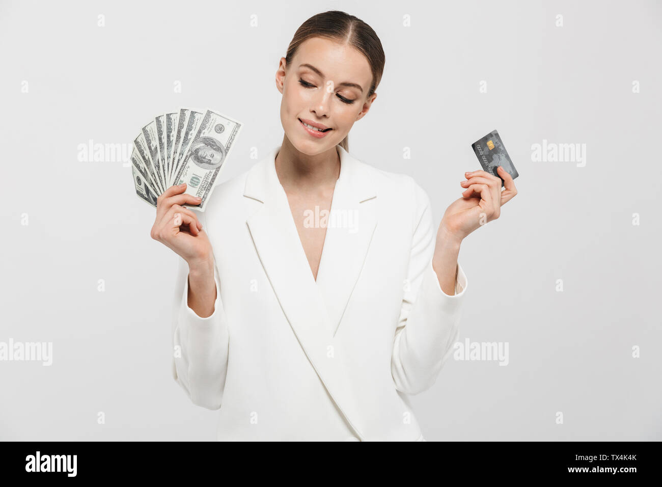 Photo of brunette businesswoman 20s wearing elegant jacket holding fan ...