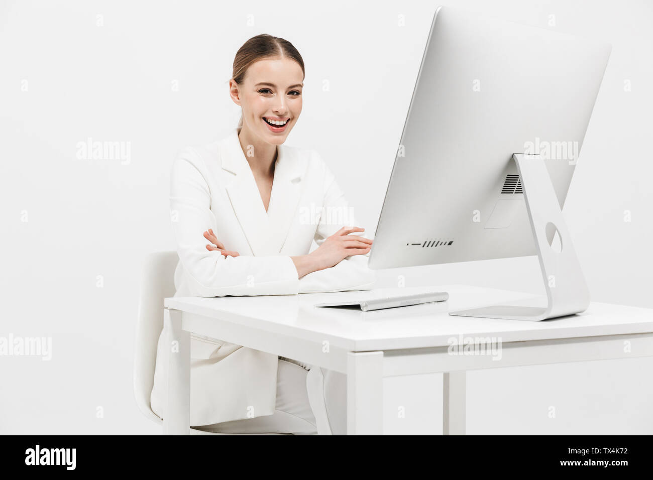 Image of a beautiful amazing woman sitting isolated over white wall ...