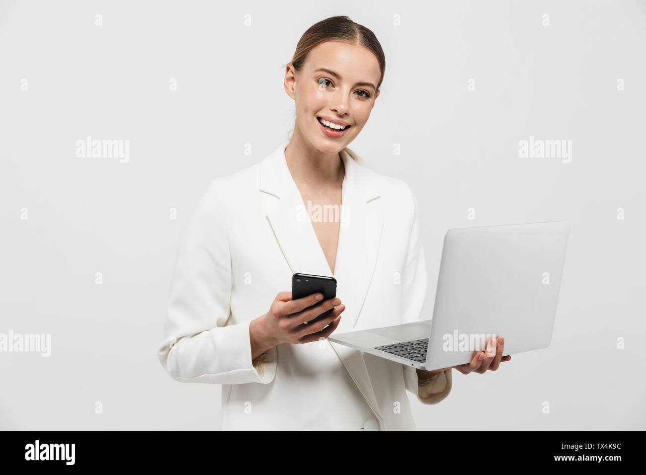 Photo of pretty businesswoman 20s wearing elegant jacket smiling while ...