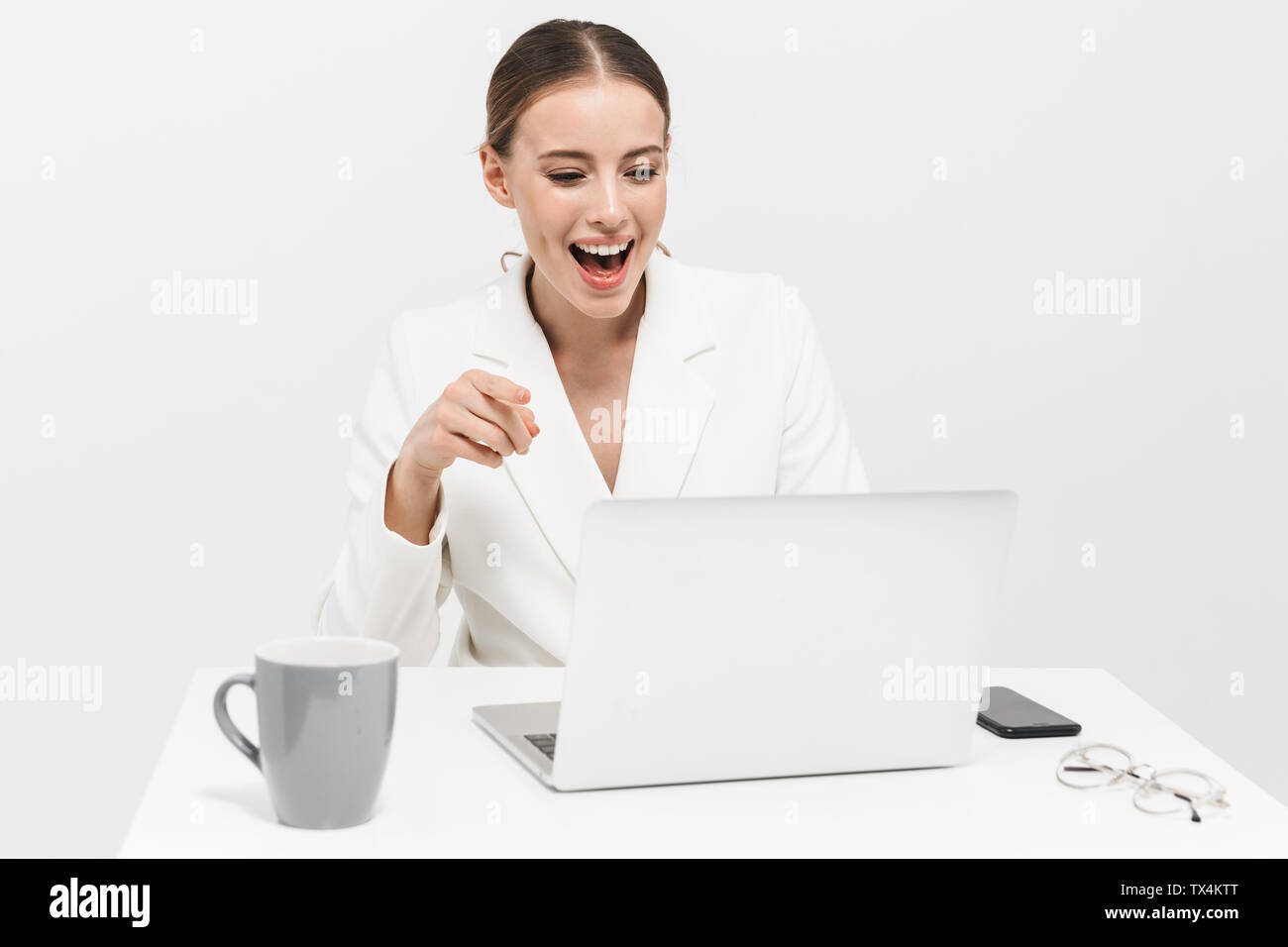 Image of a beautiful happy woman posing isolated over white wall ...
