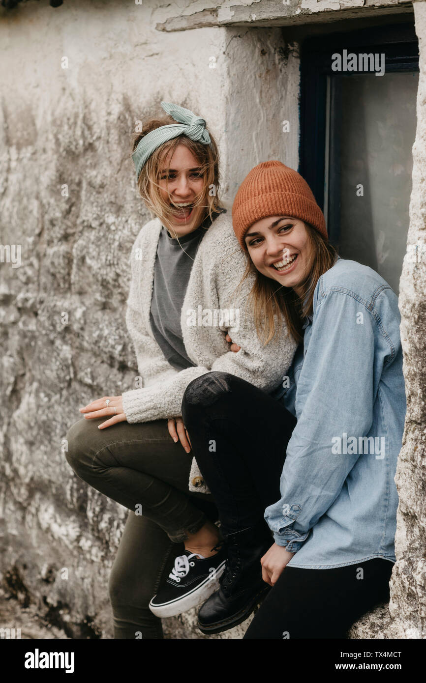 UK, Scotland, two laughing young women at a building Stock Photo - Alamy