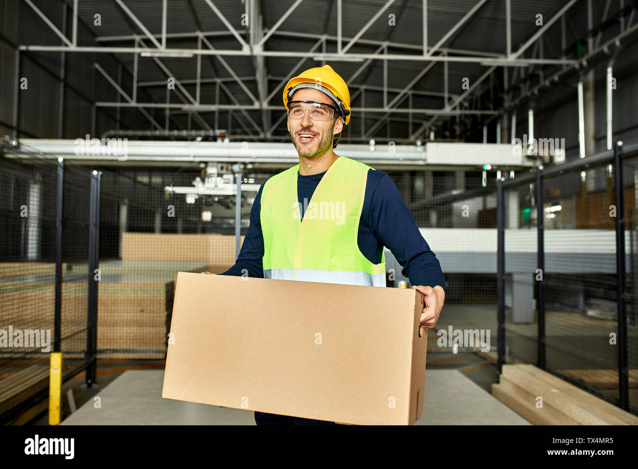 Worker carrying cardboard box hi-res stock photography and images - Alamy