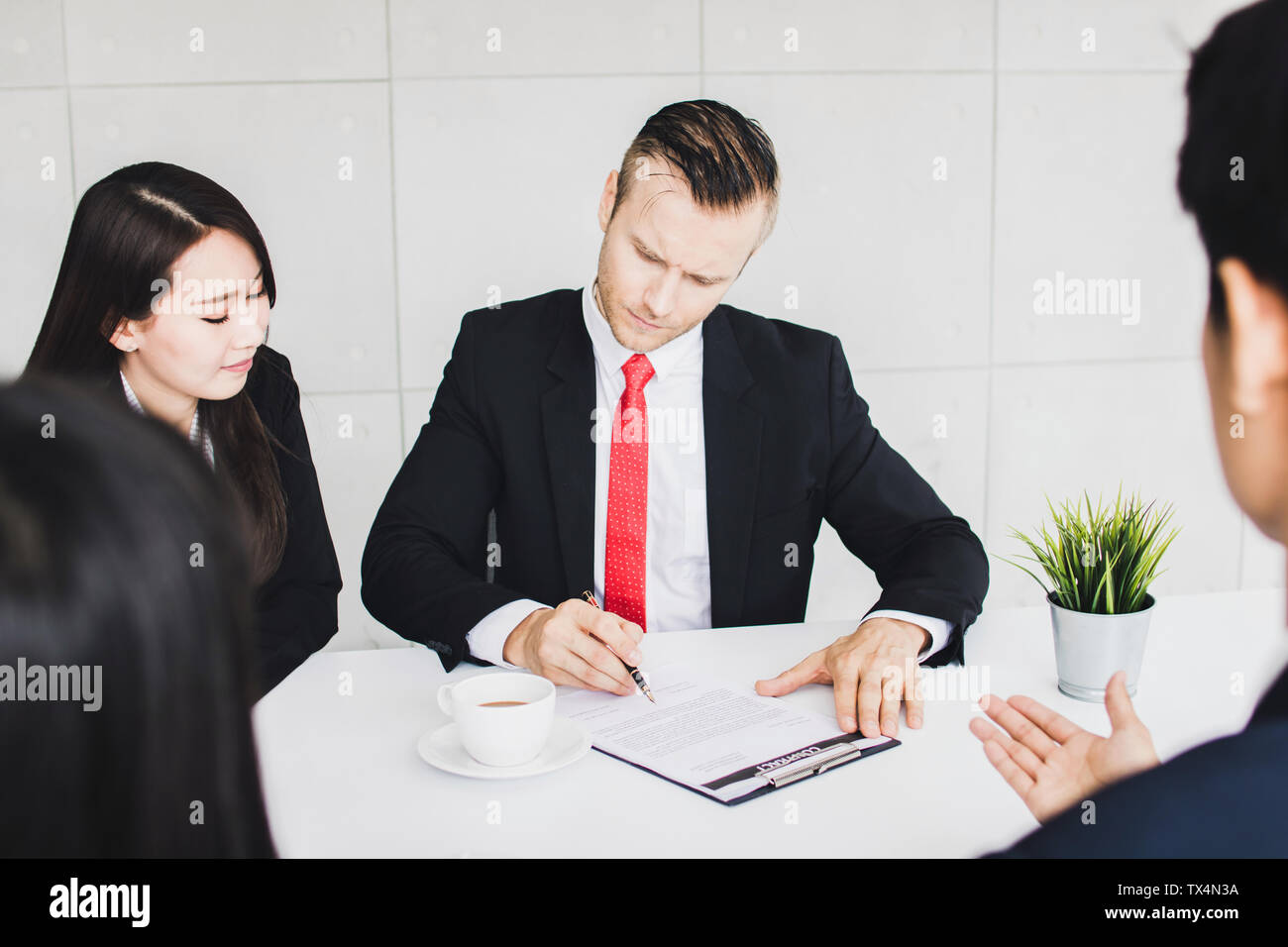 Asian man signing contract hi-res stock photography and images - Alamy