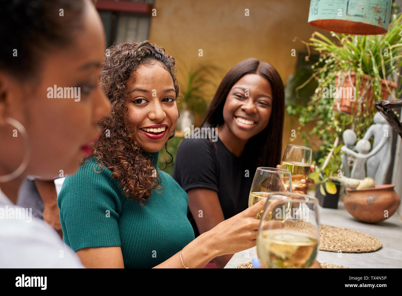 Three friends sitting in a restaurant having fun Stock Photo - Alamy