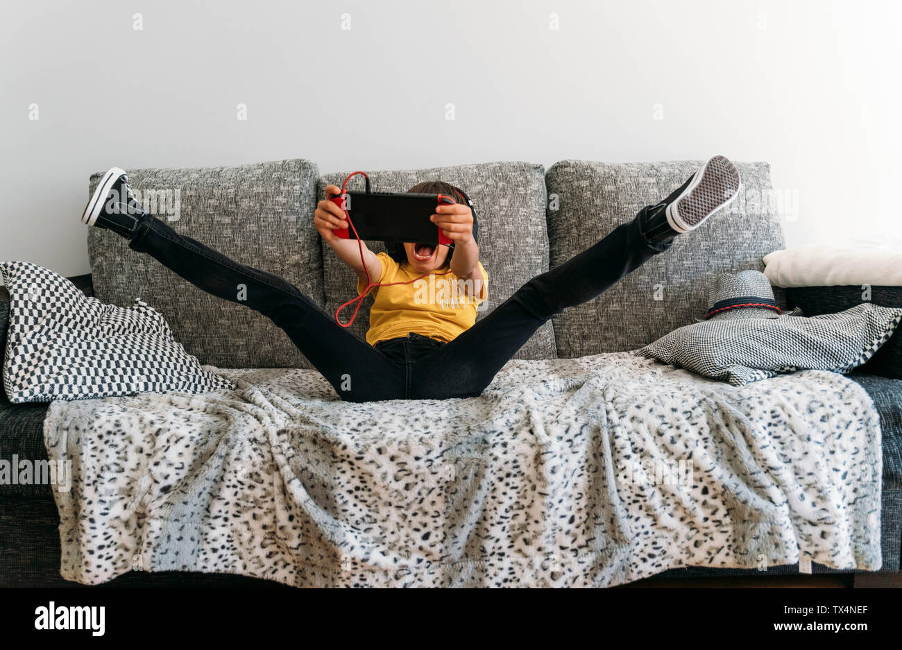 Excited boy playing video game on a games console Stock Photo - Alamy