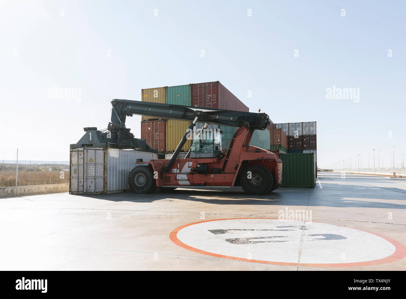 Crane and stack of containers on industrial site Stock Photo - Alamy