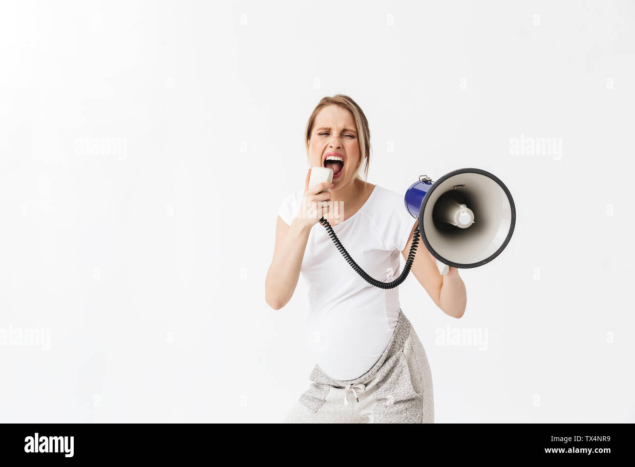 Image of a screaming beautiful young pregnant woman posing isolated ...