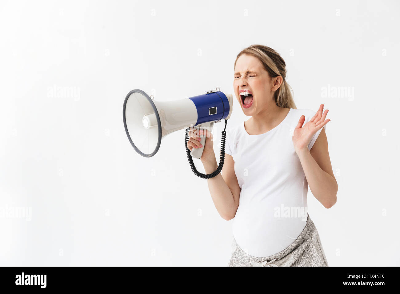Image of a screaming beautiful young pregnant woman posing isolated ...