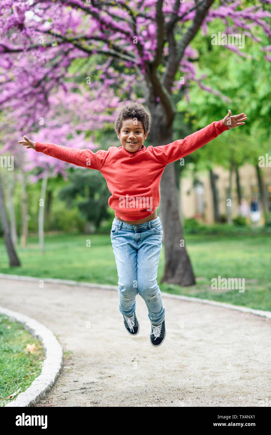 Happy boy jumping in a park Stock Photo - Alamy