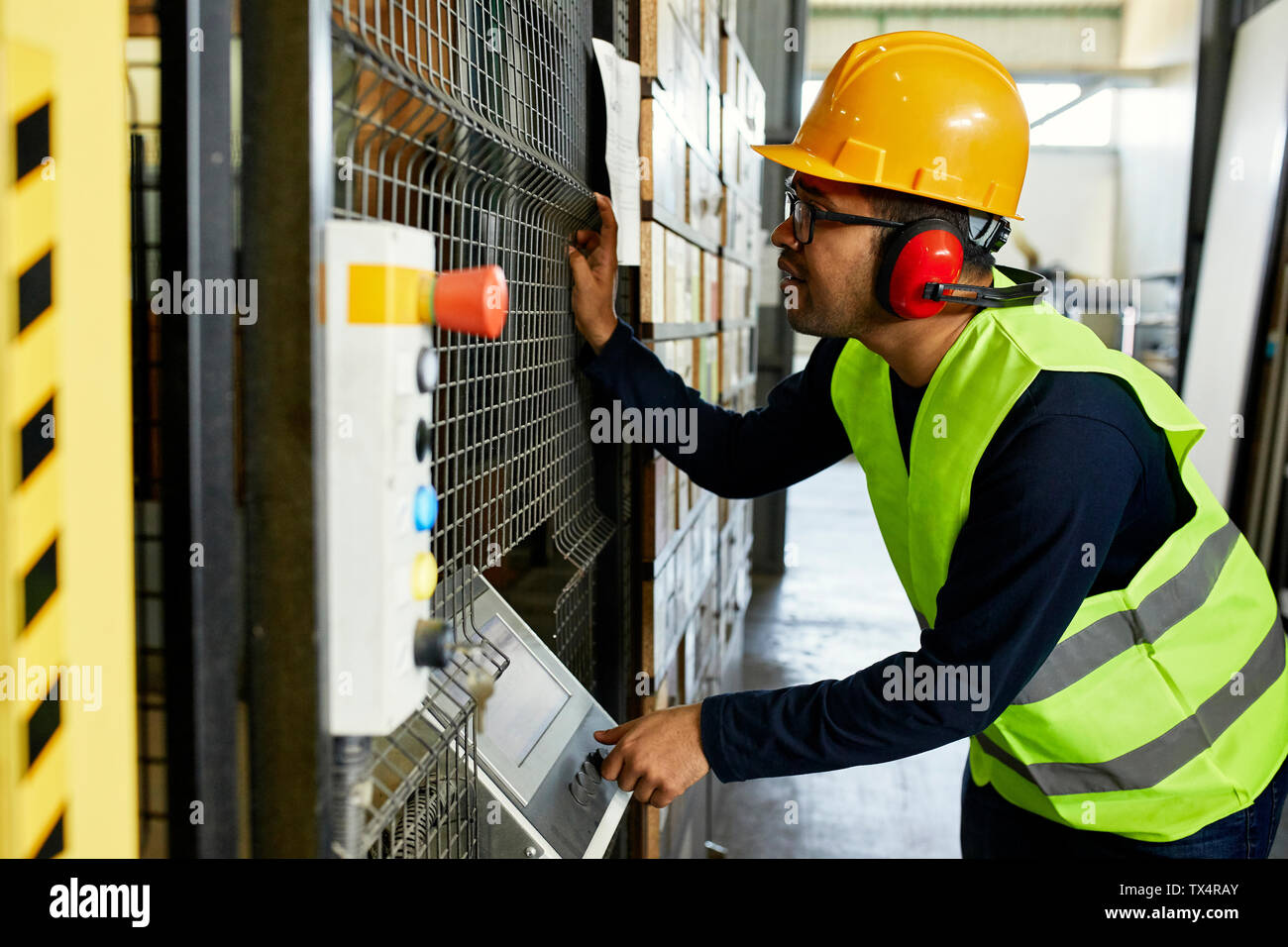 Man operating machine in industrial factory Stock Photo - Alamy
