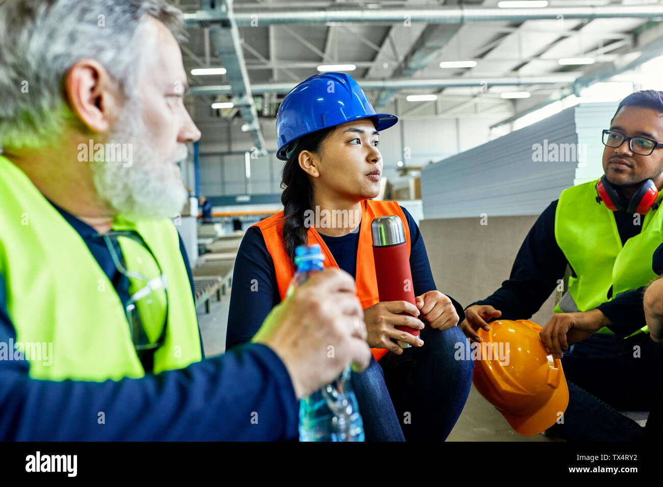 Workers in factory having lunch break together Stock Photo - Alamy