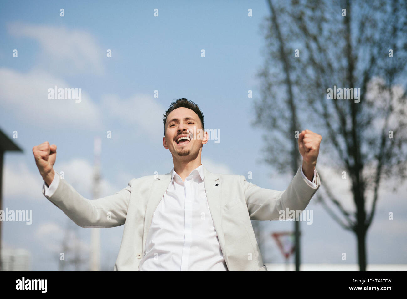 Portrait of businessman, clenching fist Stock Photo - Alamy