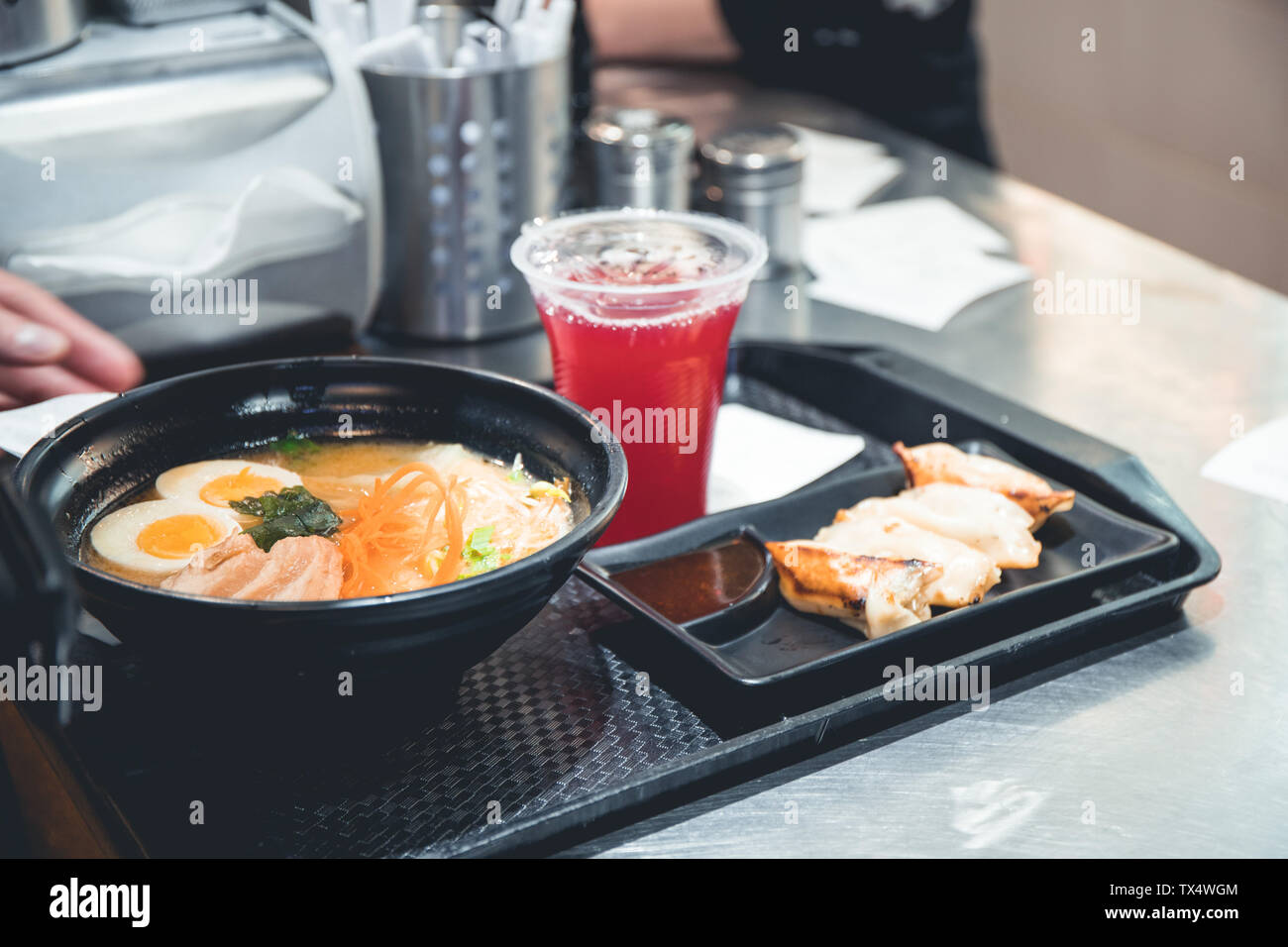 Ramen soup with pork dumplings on a plastic tray in a Japanese fast ...