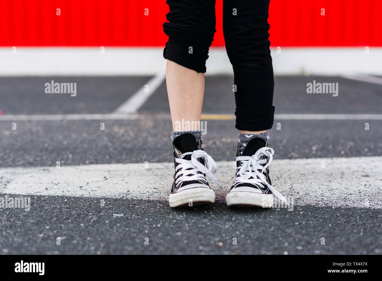 Girl with one trouser leg rolled up, partial view Stock Photo - Alamy