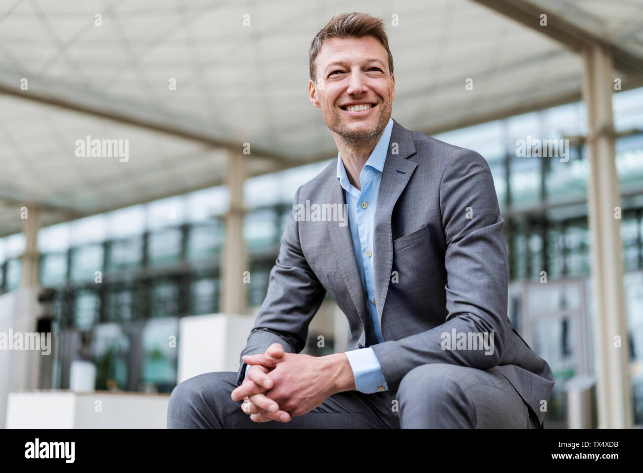 Relaxed man sitting outside hi-res stock photography and images - Alamy