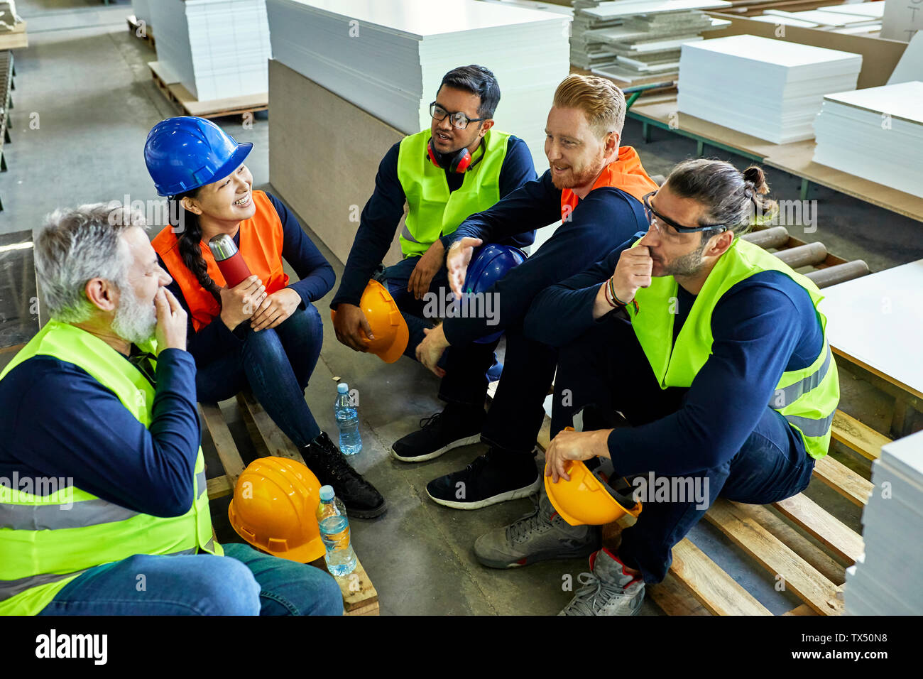 Workers in factory having lunch break together Stock Photo - Alamy