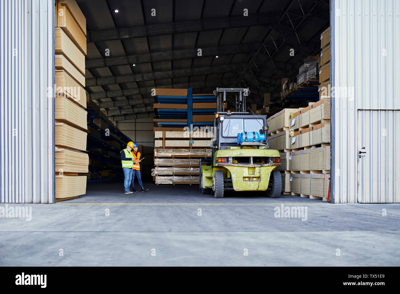 Woman standing next to forklift hi-res stock photography and images - Alamy