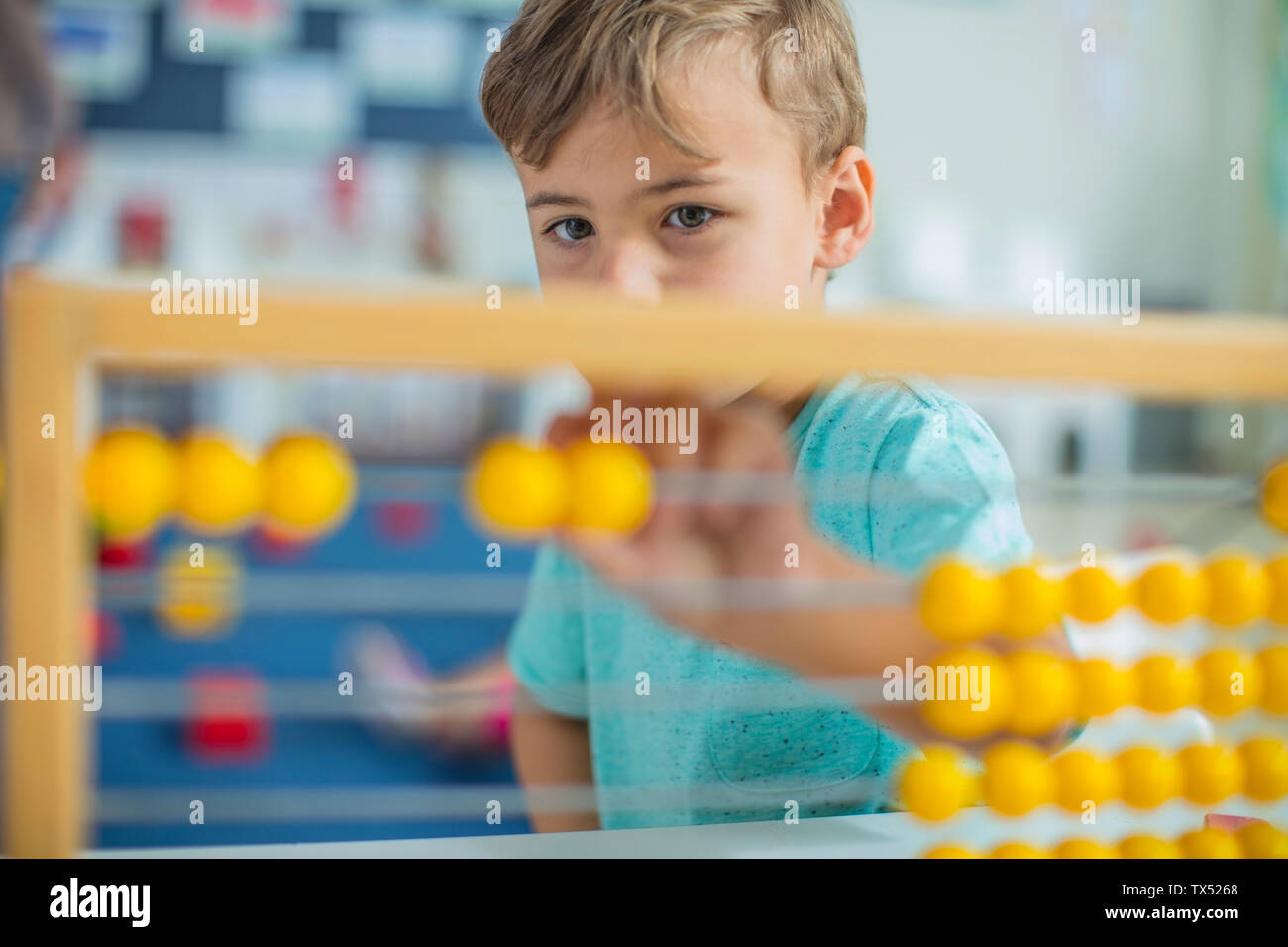 Boy in kindergarten using abacus Stock Photo - Alamy
