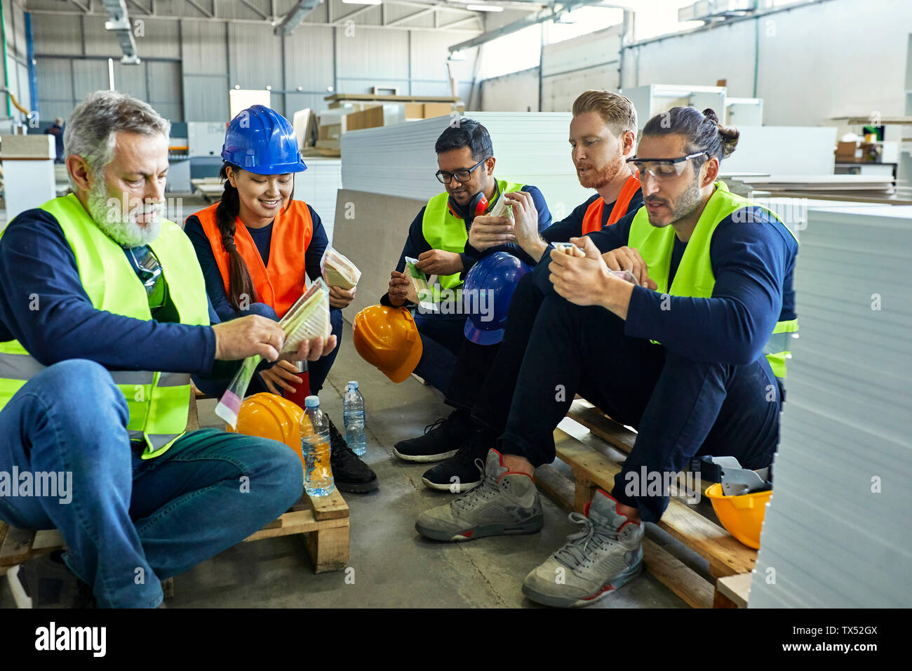 Workers in factory having lunch break together Stock Photo - Alamy