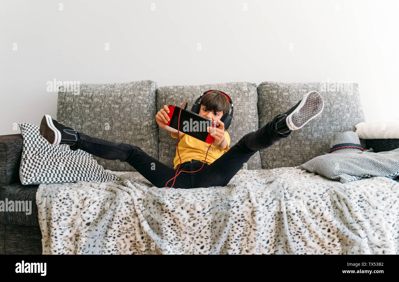 Excited boy playing video game on a games console Stock Photo - Alamy