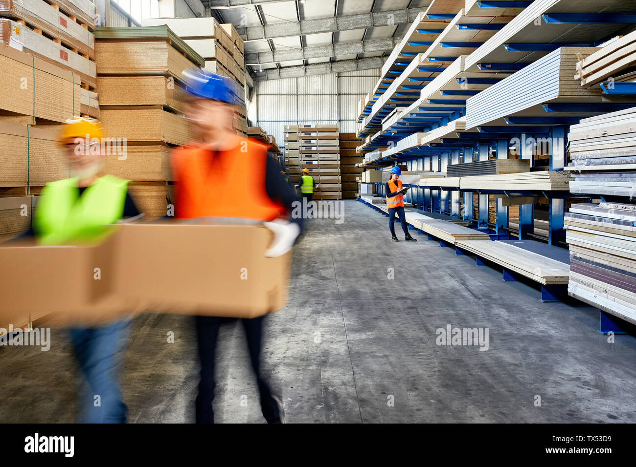 Workers moving and carrying boxes in factory warehouse Stock Photo - Alamy