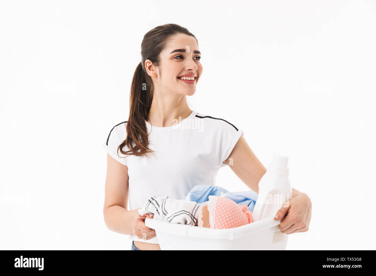 Photo of lovely woman housewife 20s dressed in casual wear carrying ...